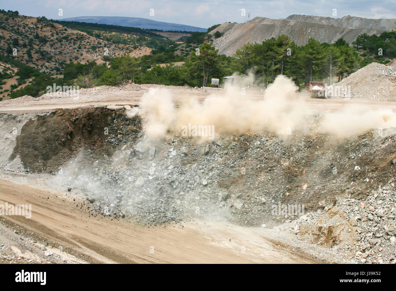 open cast mine after blast among dust and smoke Stock Photo - Alamy