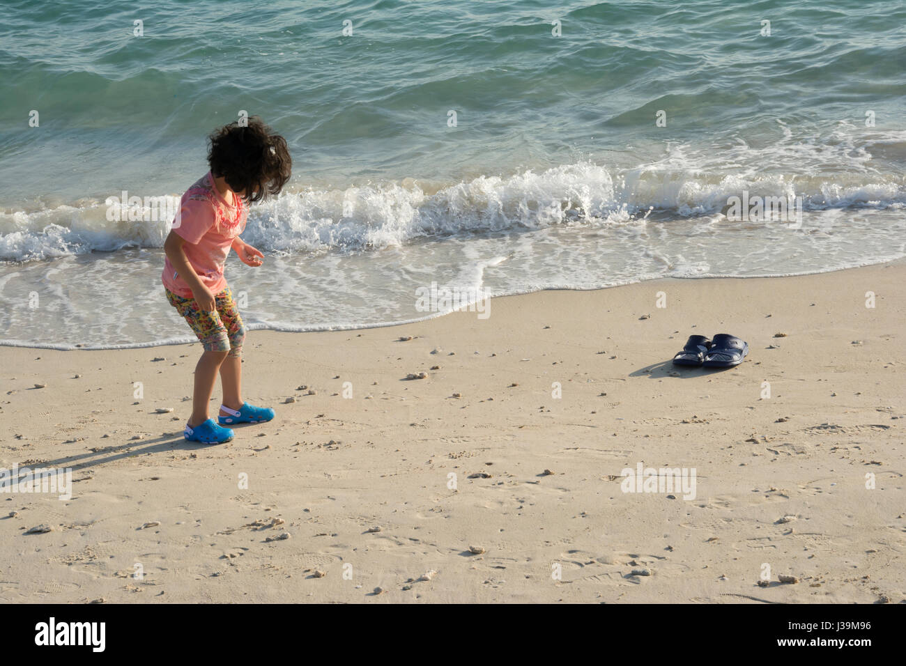Girl playing with shells hi-res stock photography and images - Alamy