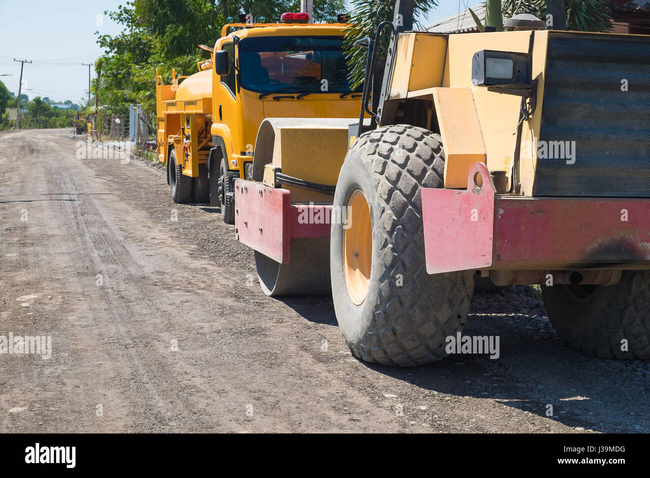 Road construction vehicle on the rough rural road. countryside Stock ...