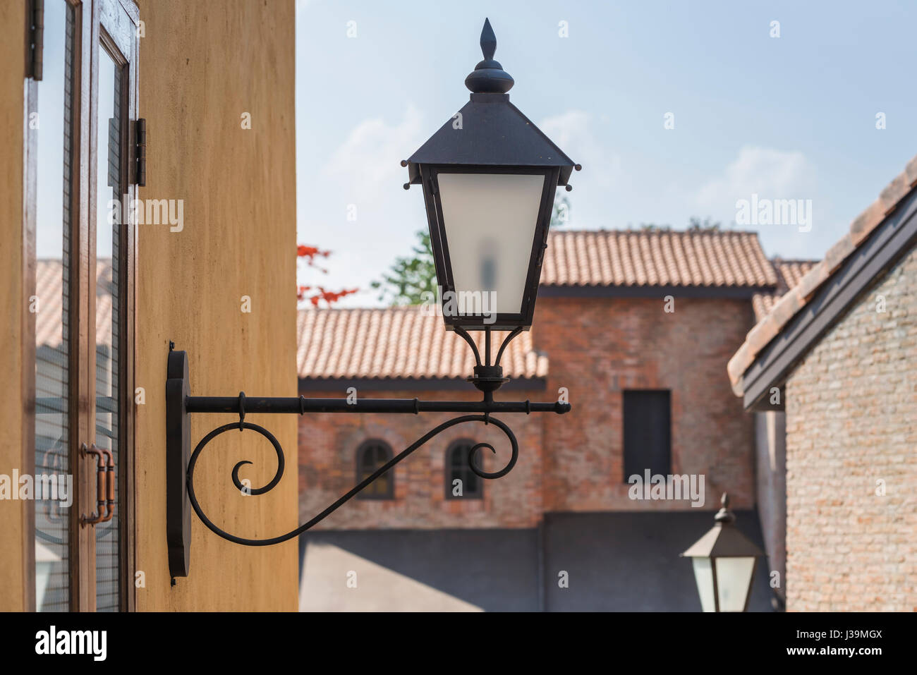 old lamp on the wall with vintage building background Stock Photo - Alamy