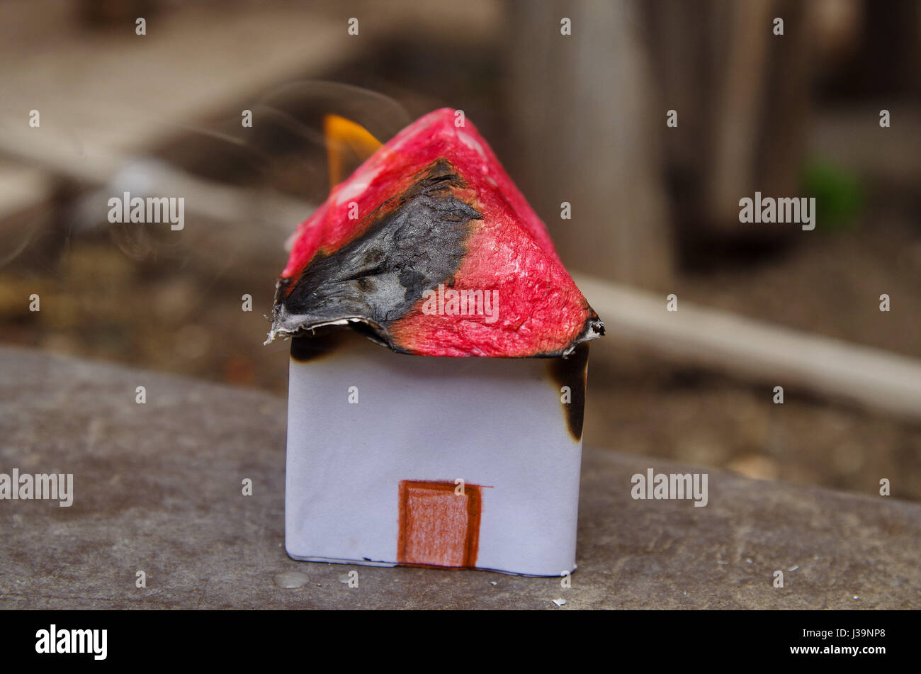 Small and beautiful house made of paper burning, house model concept ...