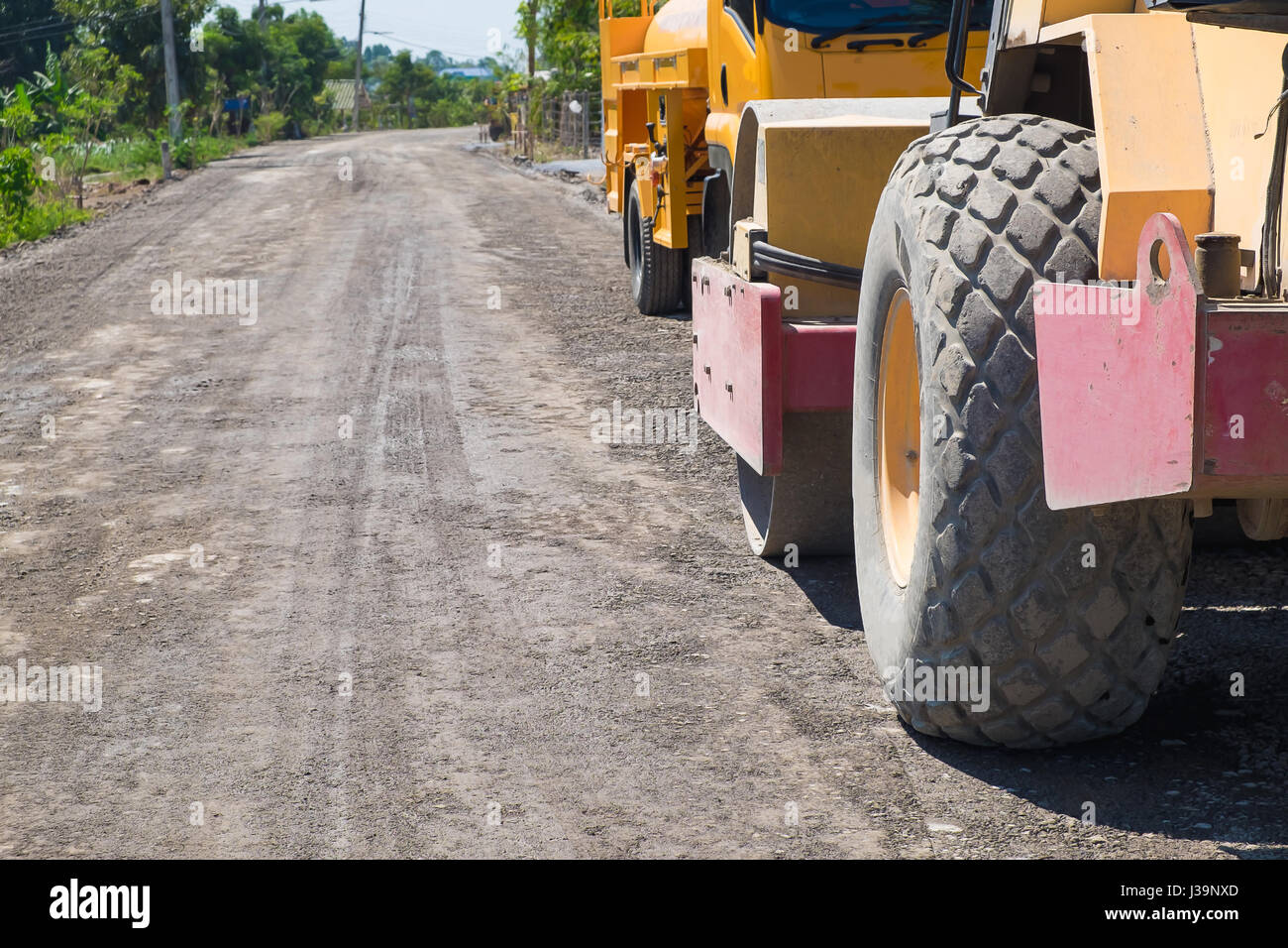 Road construction vehicle on the rough rural road. countryside Stock ...