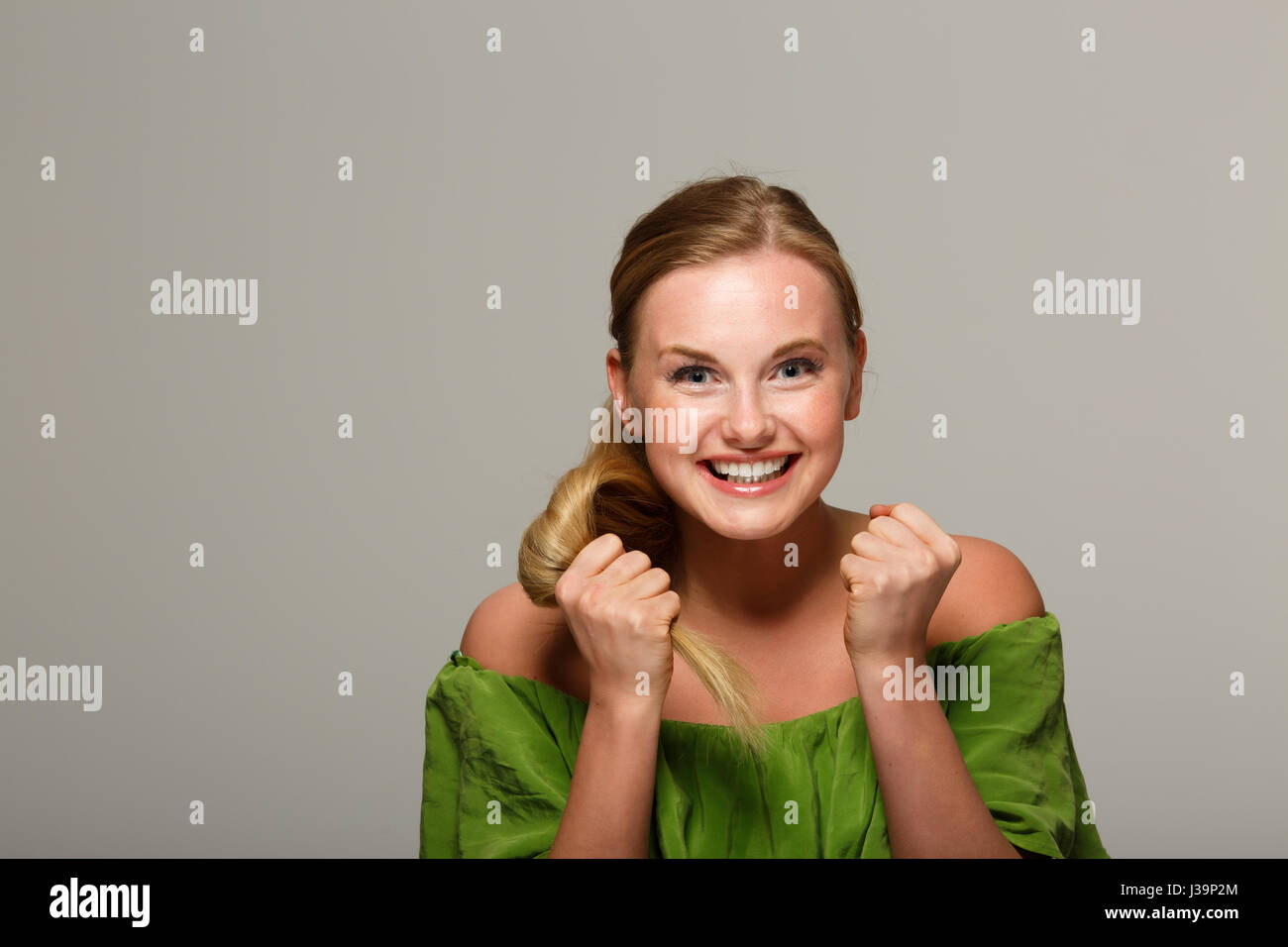 Cheerful woman in green dress Stock Photo - Alamy
