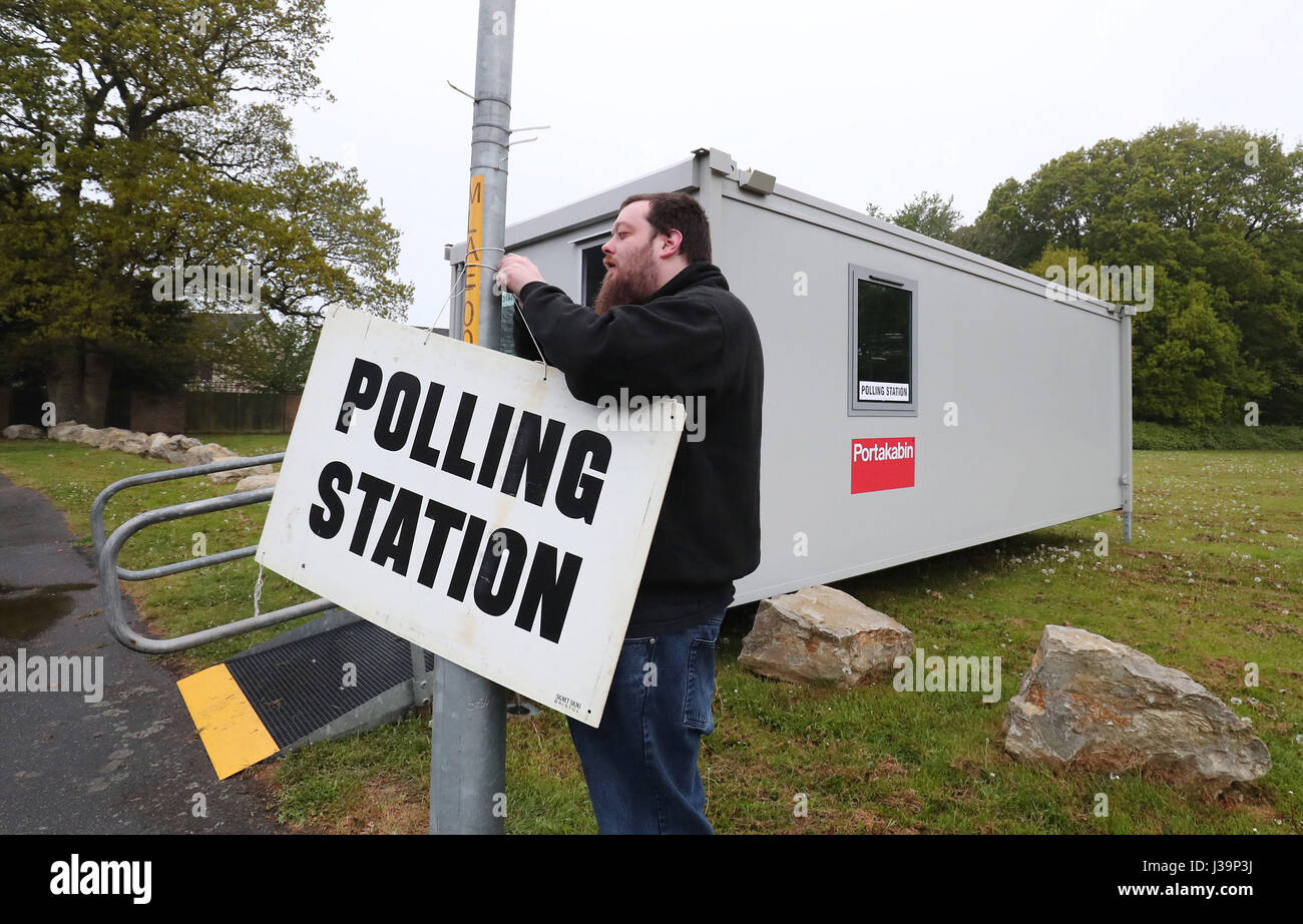 A poll clerk sets up a polling station within a kabin in Ashford, Kent ...