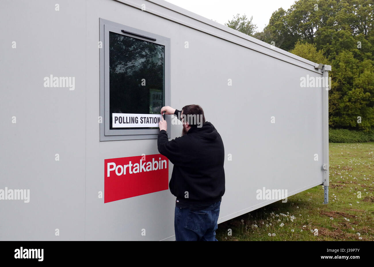 A poll clerk sets up a polling station within a kabin in Ashford, Kent ...