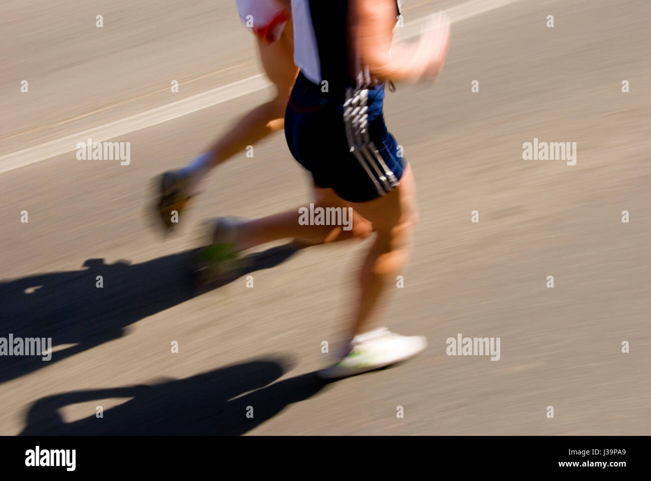legs of two marathon runners Stock Photo - Alamy