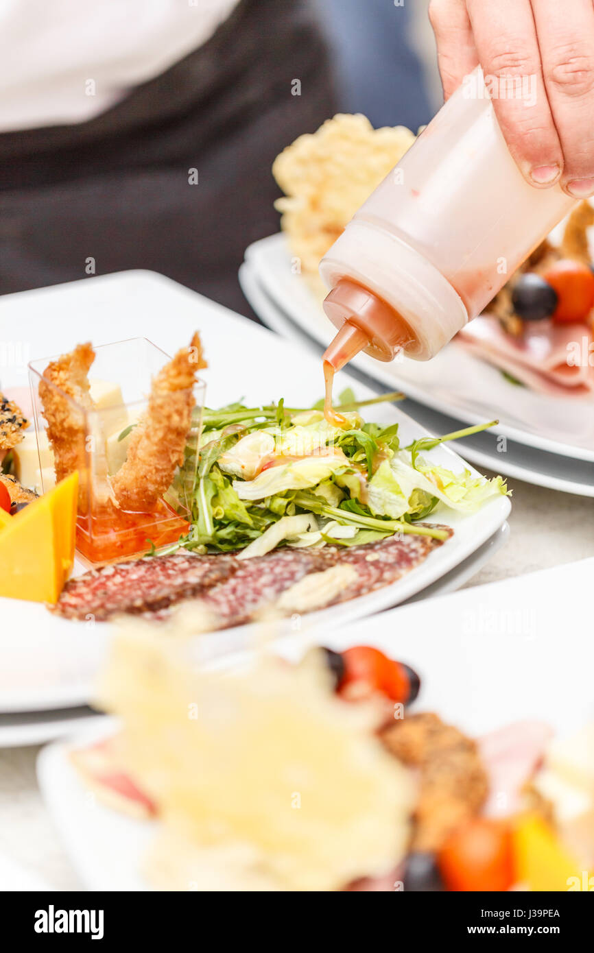 Chef preparing appetizers commercial kitchen hi-res stock photography ...