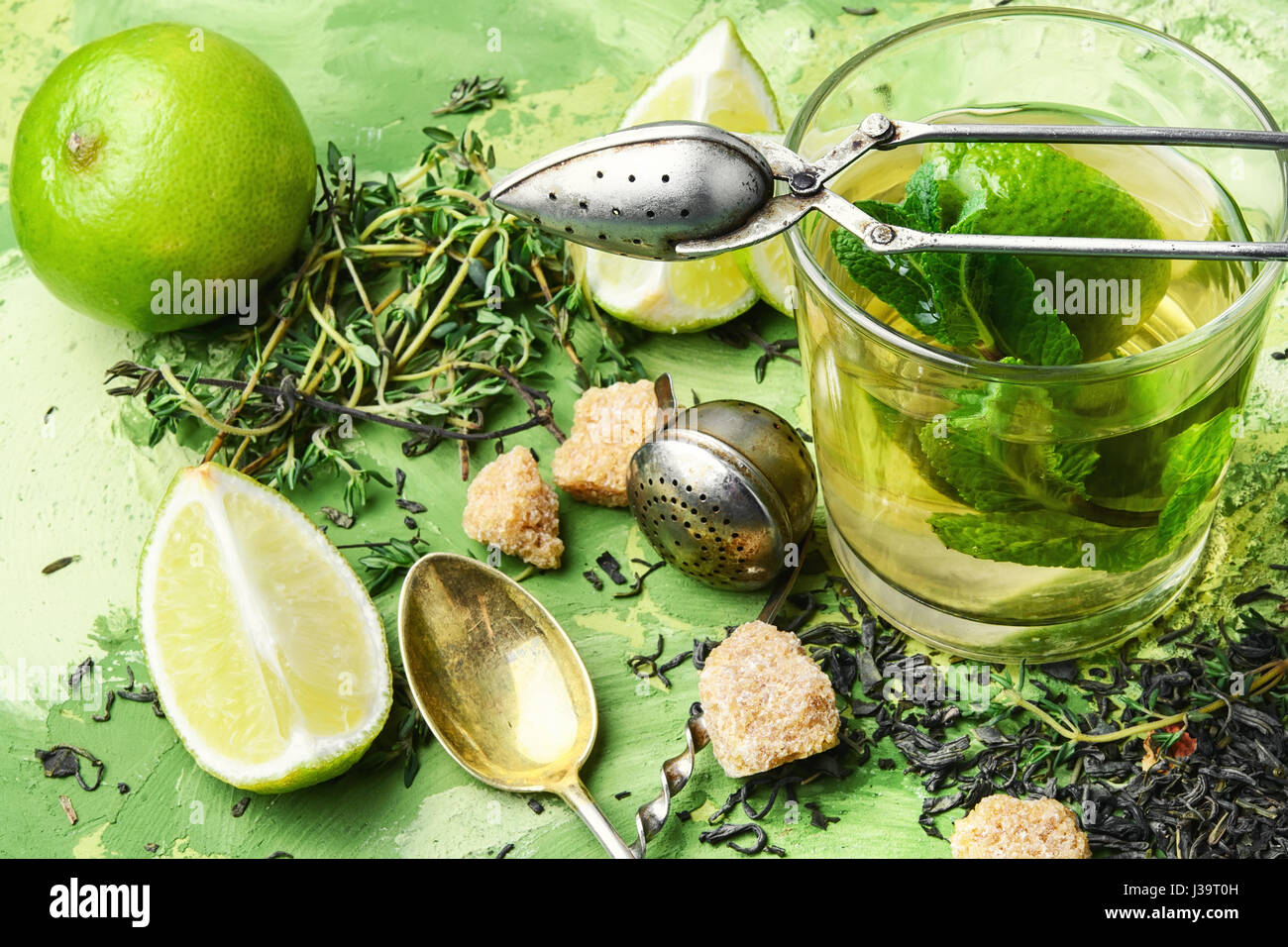 Dry tea leaves,fresh thyme,lime fruit for tea Stock Photo - Alamy