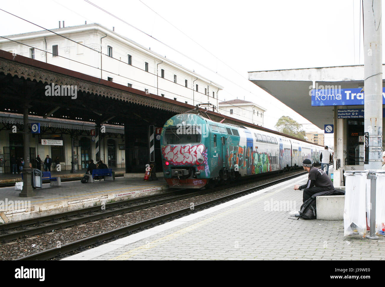 Passengers waiting for the cororful train at Trastevere railway station ...