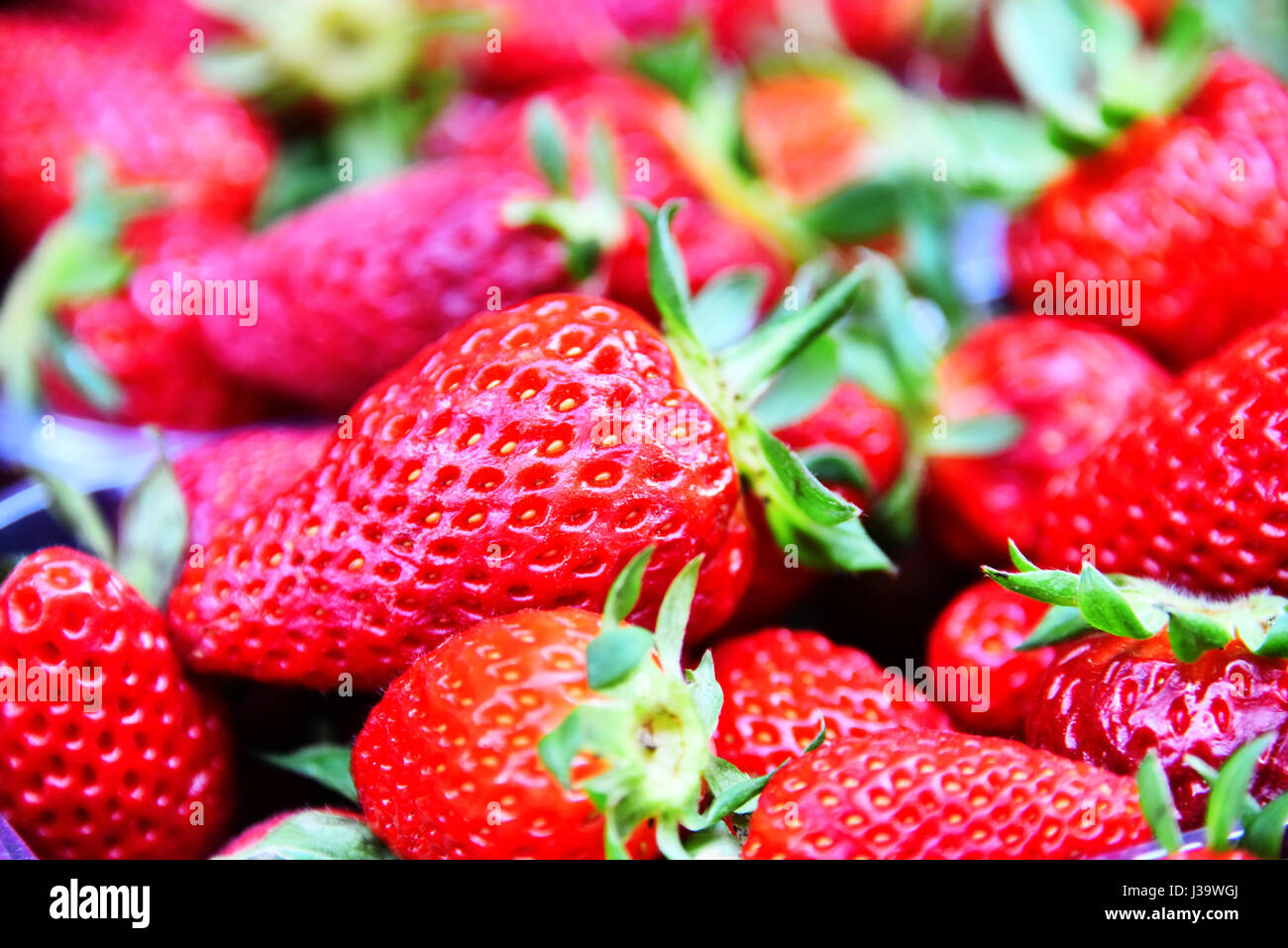 Fresh strawberries on street market stall Stock Photo - Alamy