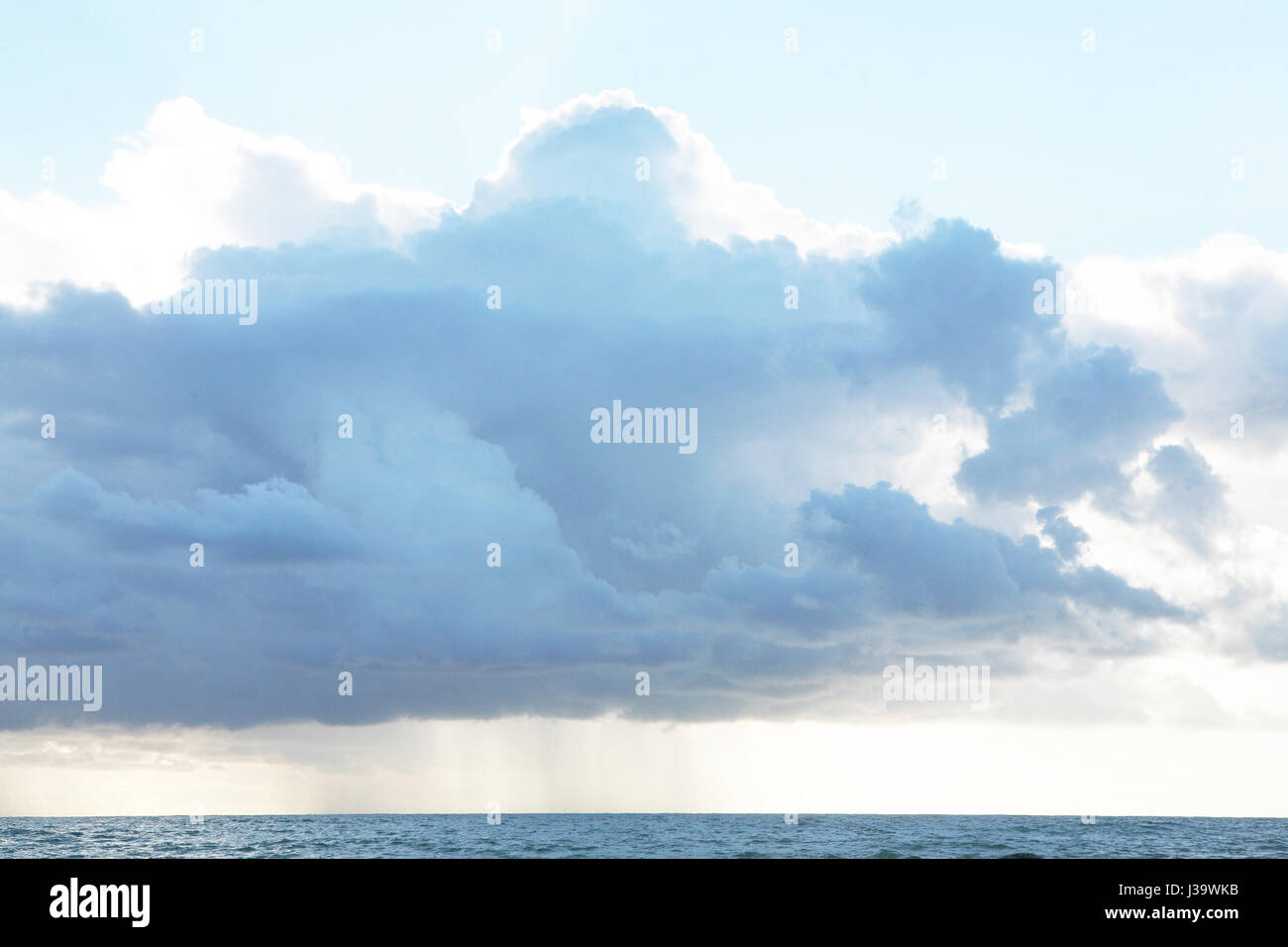 Storm rain cloud and sun over the sea Stock Photo - Alamy