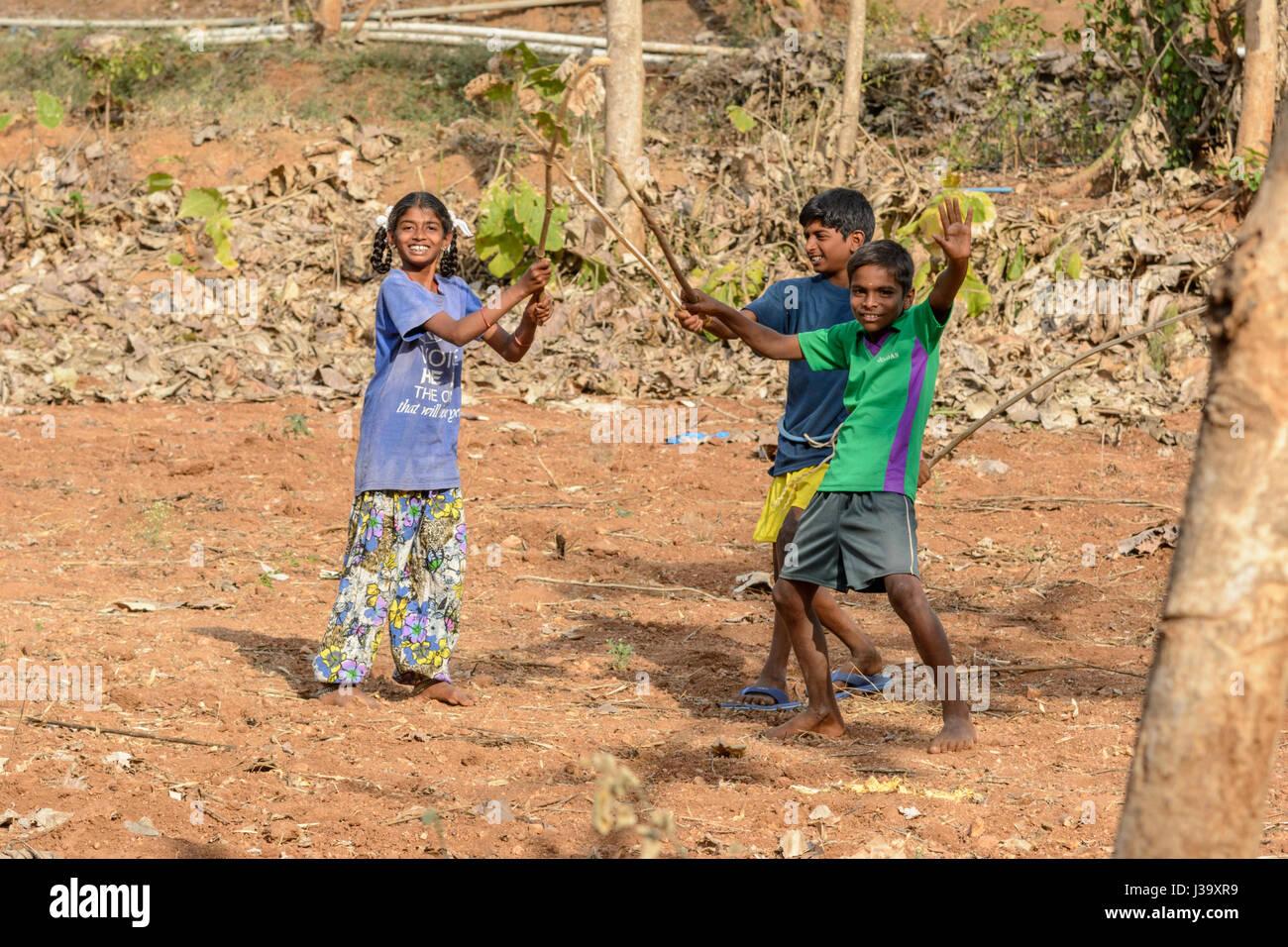 Tamil children playing with sticks in a rural village in Tamil Nadu ...