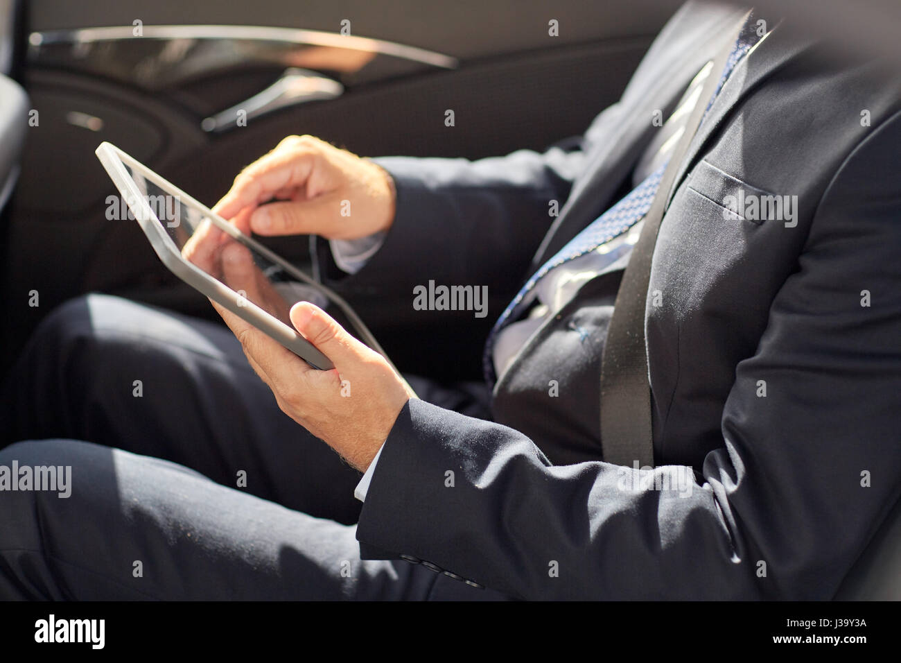 senior businessman with tablet pc driving in car Stock Photo - Alamy