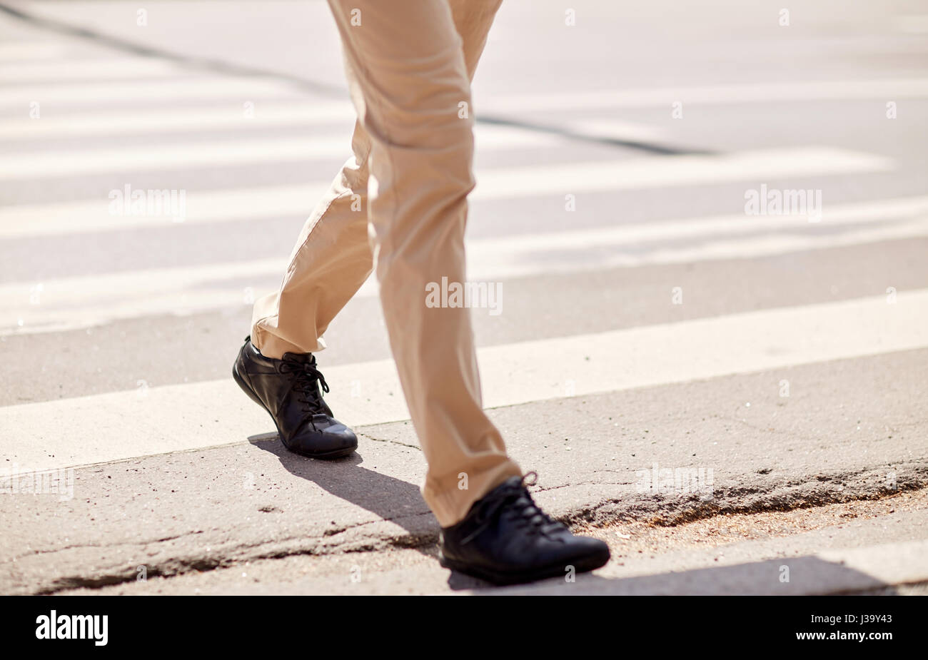 senior man walking along city crosswalk Stock Photo - Alamy