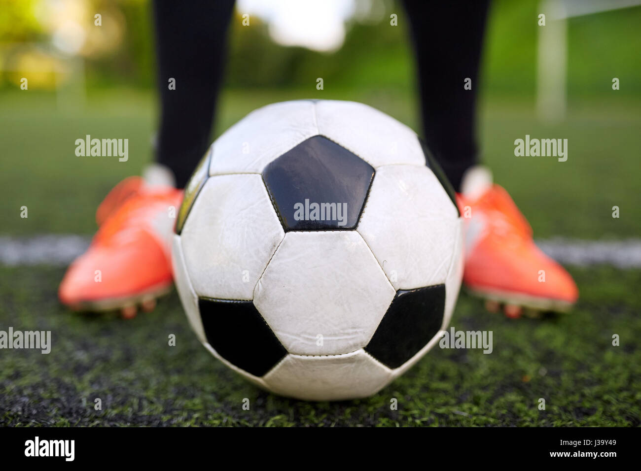 soccer player playing with ball on football field Stock Photo - Alamy