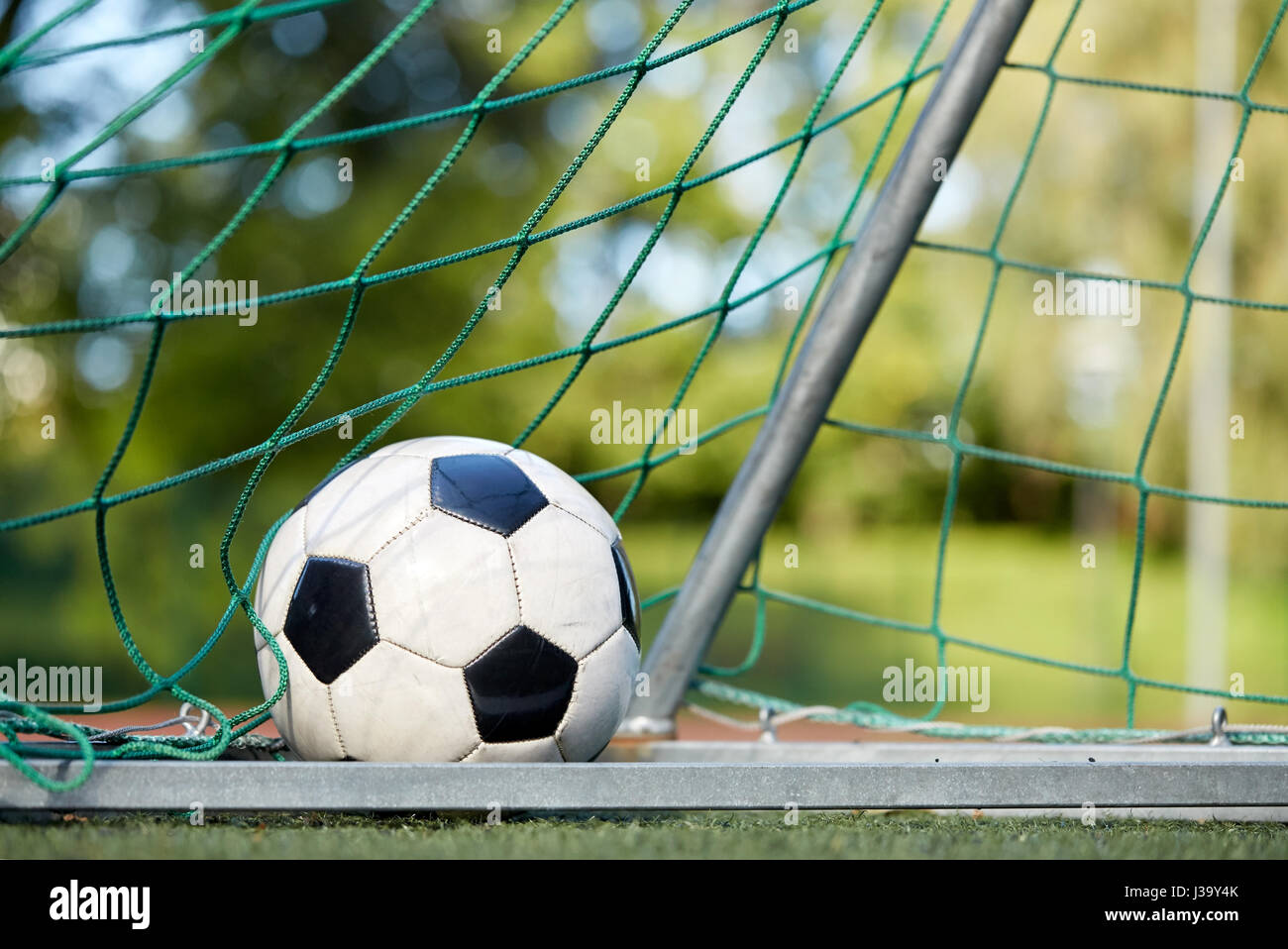 soccer ball at goal net on football field Stock Photo - Alamy