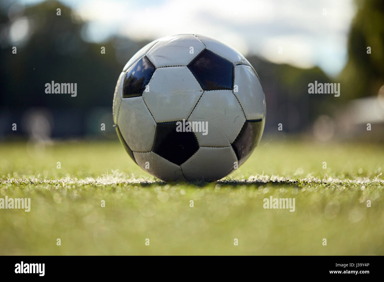 soccer ball on football field Stock Photo - Alamy