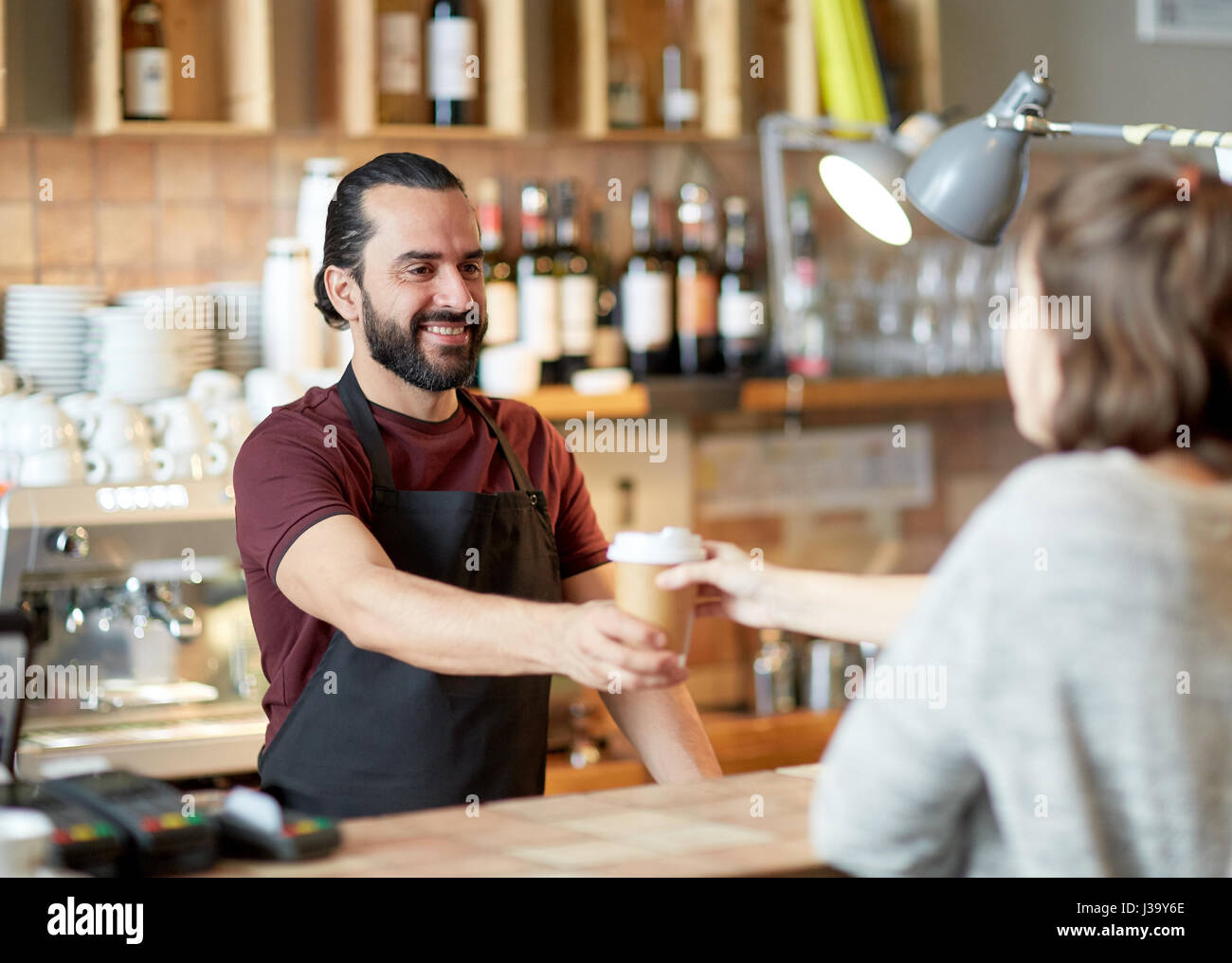 man or waiter serving customer in coffee shop Stock Photo - Alamy