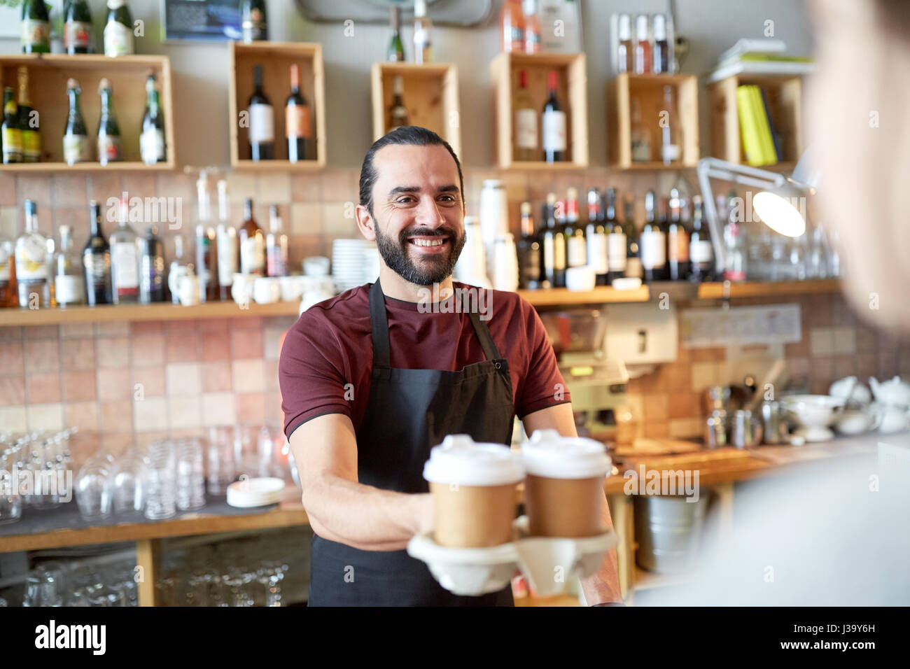 man or waiter serving customer in coffee shop Stock Photo - Alamy