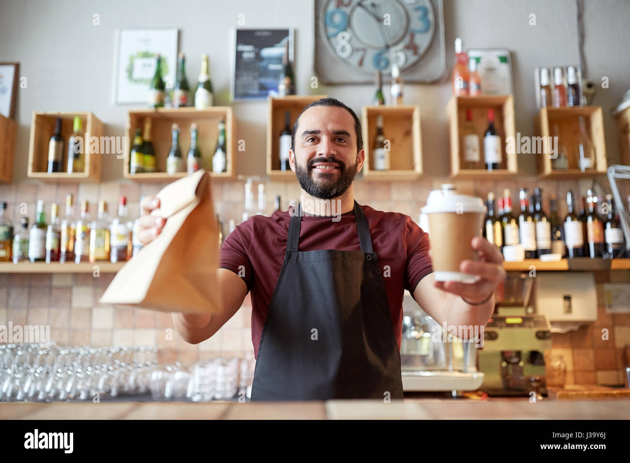 man or waiter with coffee and paper bag at bar Stock Photo - Alamy