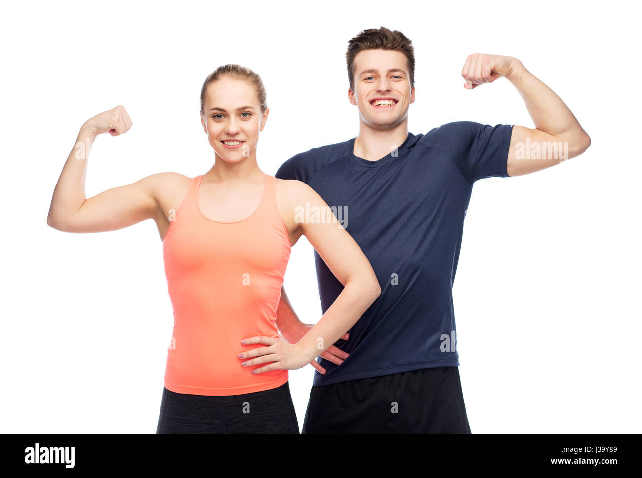 happy sportive man and woman showing biceps power Stock Photo - Alamy