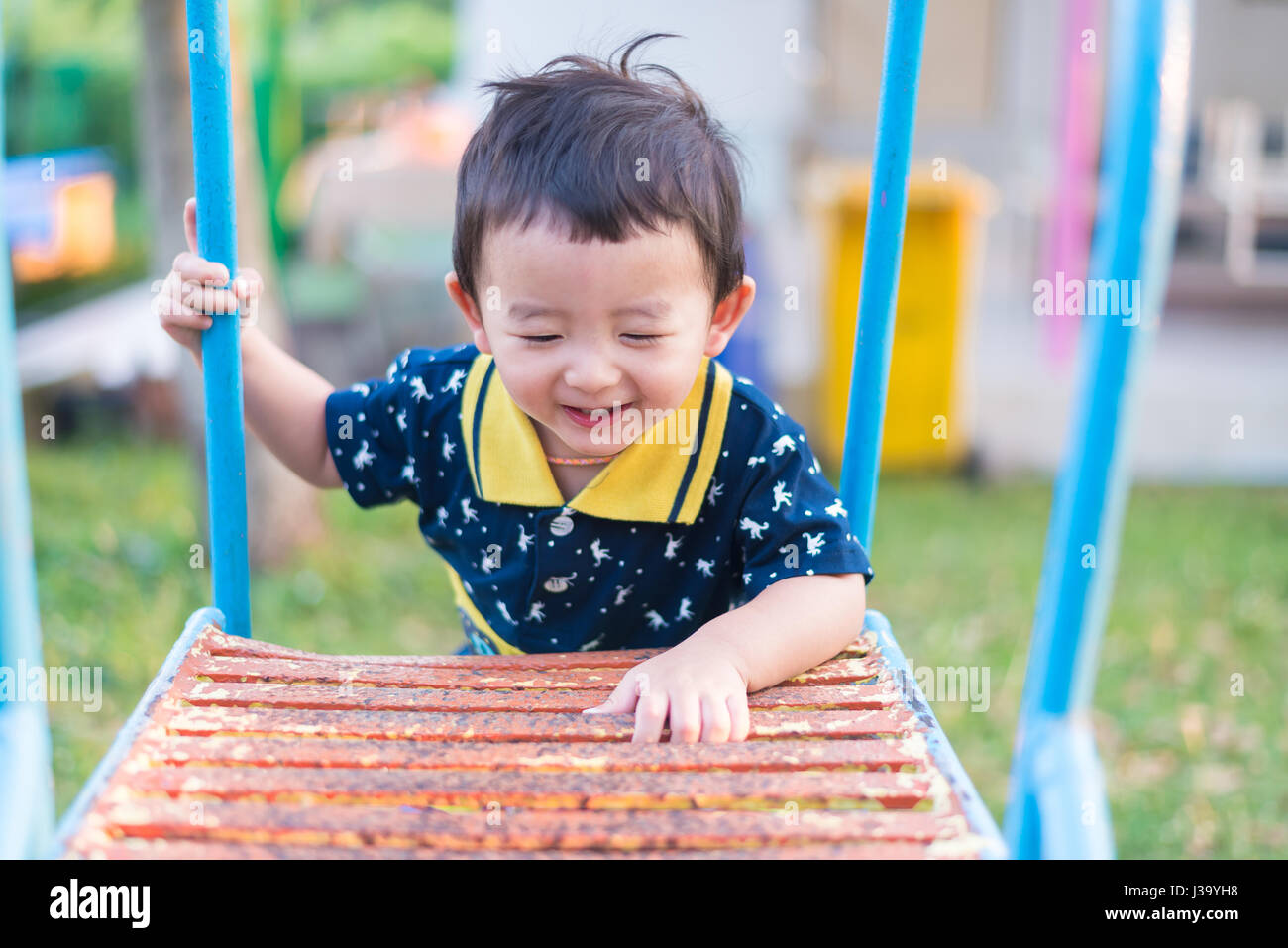 Asian kid goes up the stairs in the park. concept of growing up. step ...