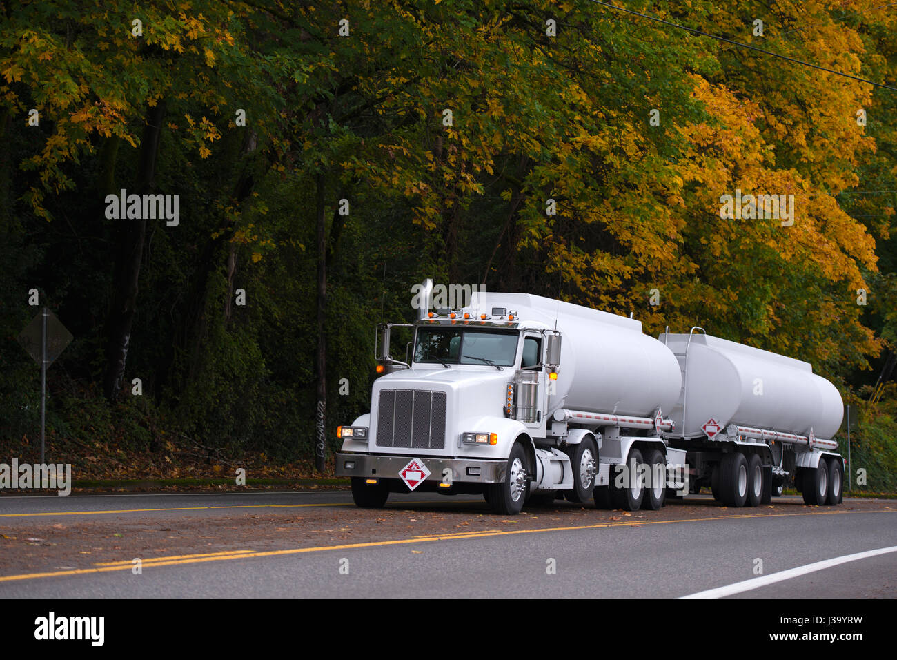 Modern white day cab semi truck with chrome grille and two tanks ...