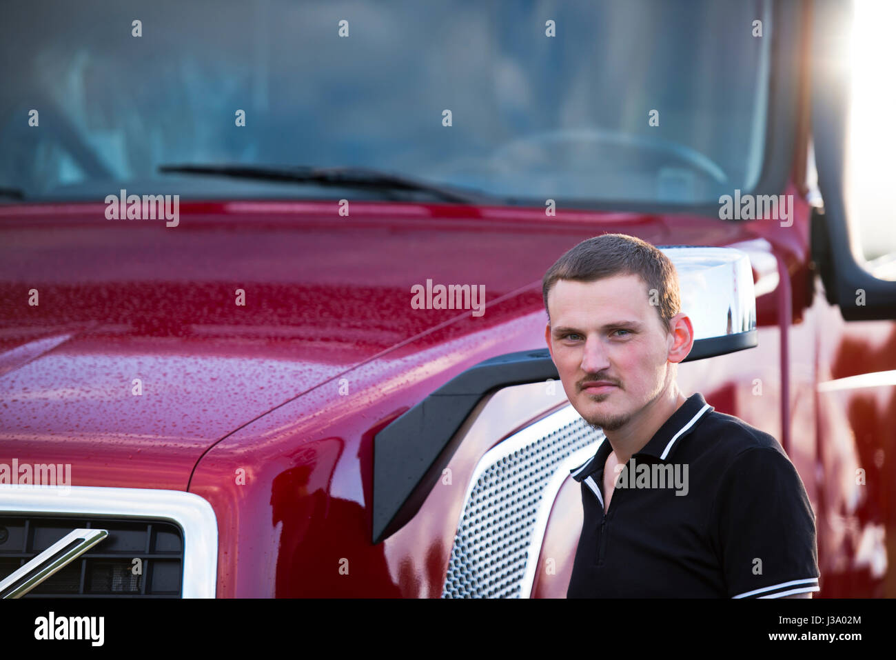 A young truck driver involved in professional freight over long ...