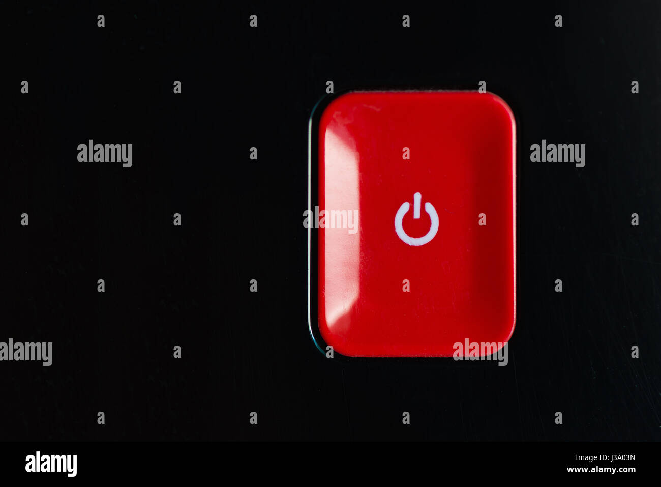 Red plastic rectangle power button with icon on black background Stock ...