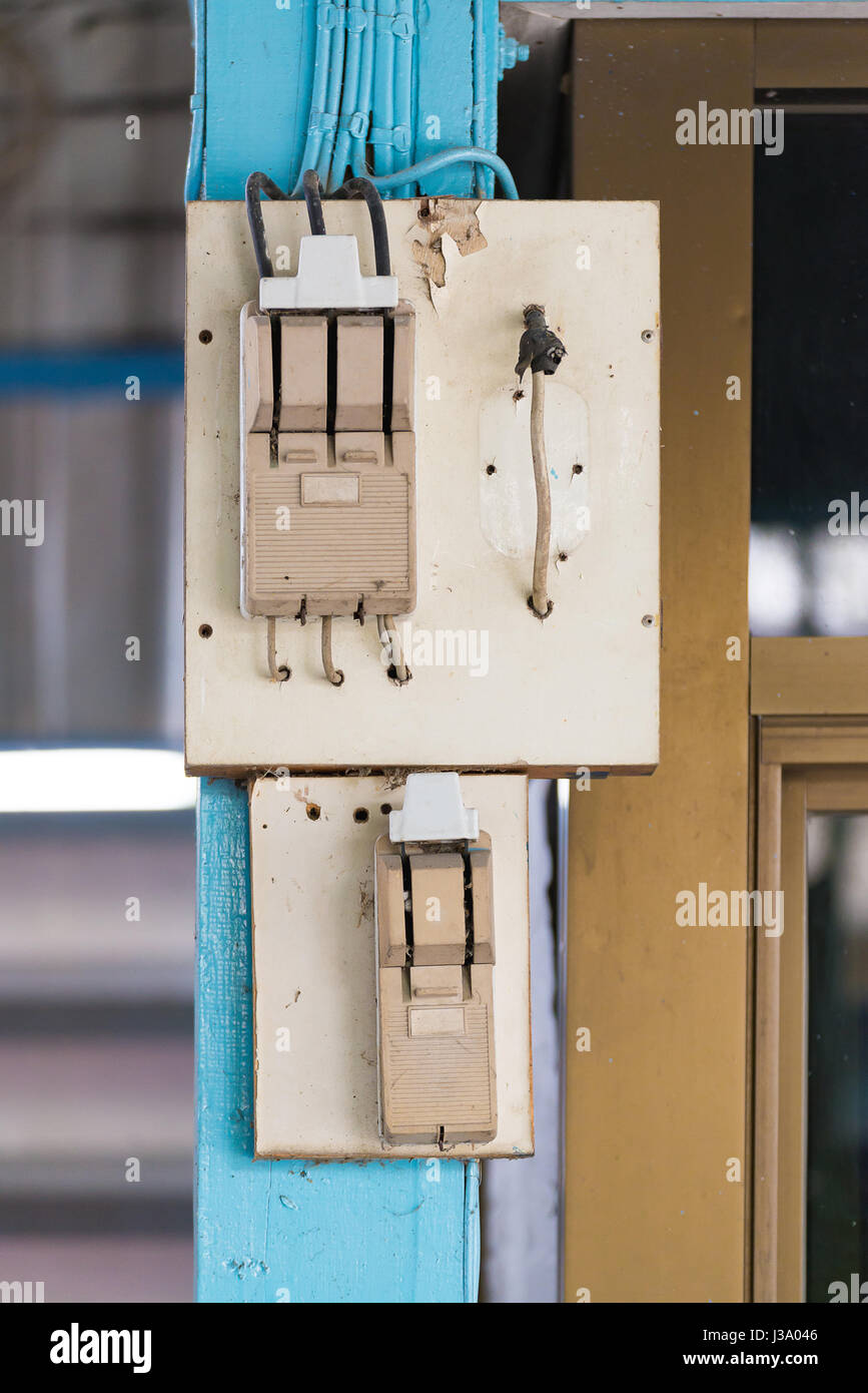 Old electrical power safety breaker with socket outlet on the wall ...