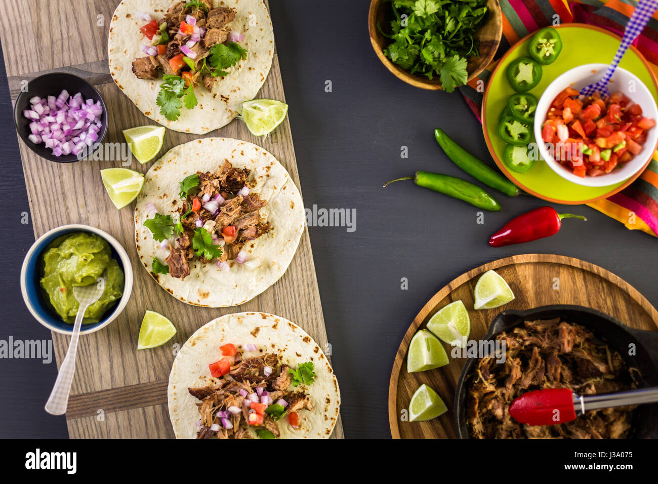Pulled pork carnitas with pico de gallo on a flour tortilla Stock Photo ...
