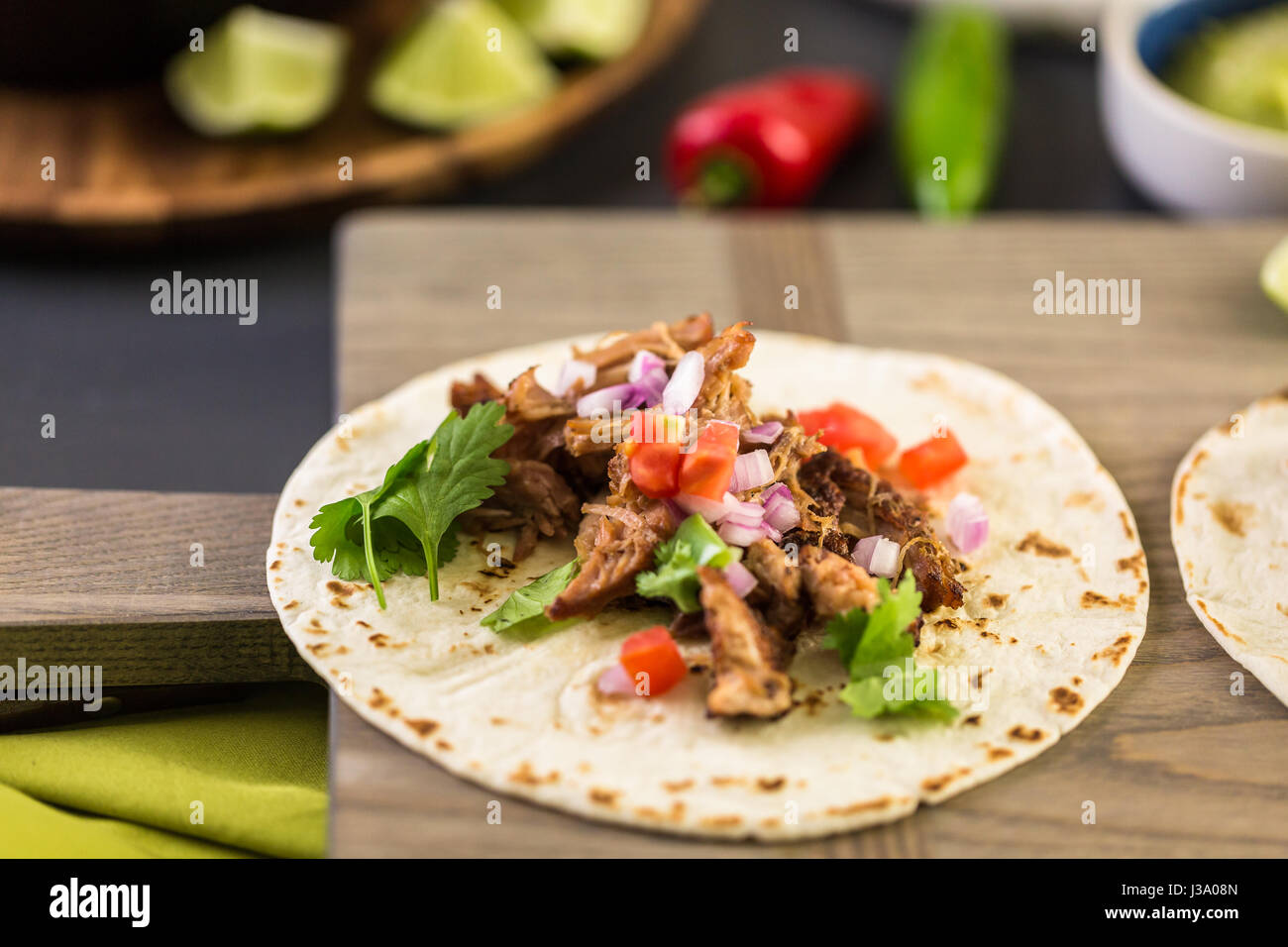 Pulled pork carnitas with pico de gallo on a flour tortilla Stock Photo ...