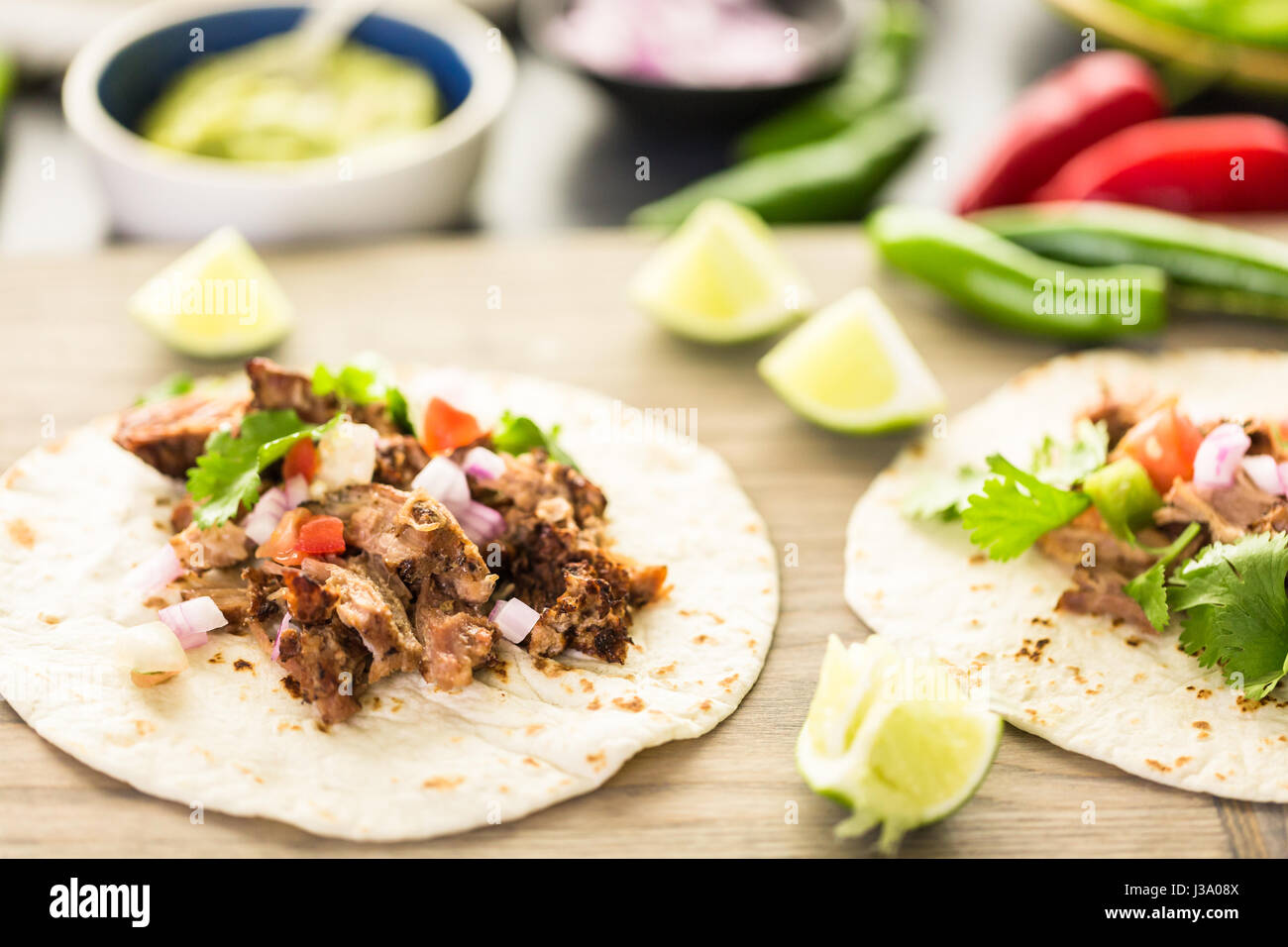 Pulled pork carnitas with pico de gallo on a flour tortilla Stock Photo ...