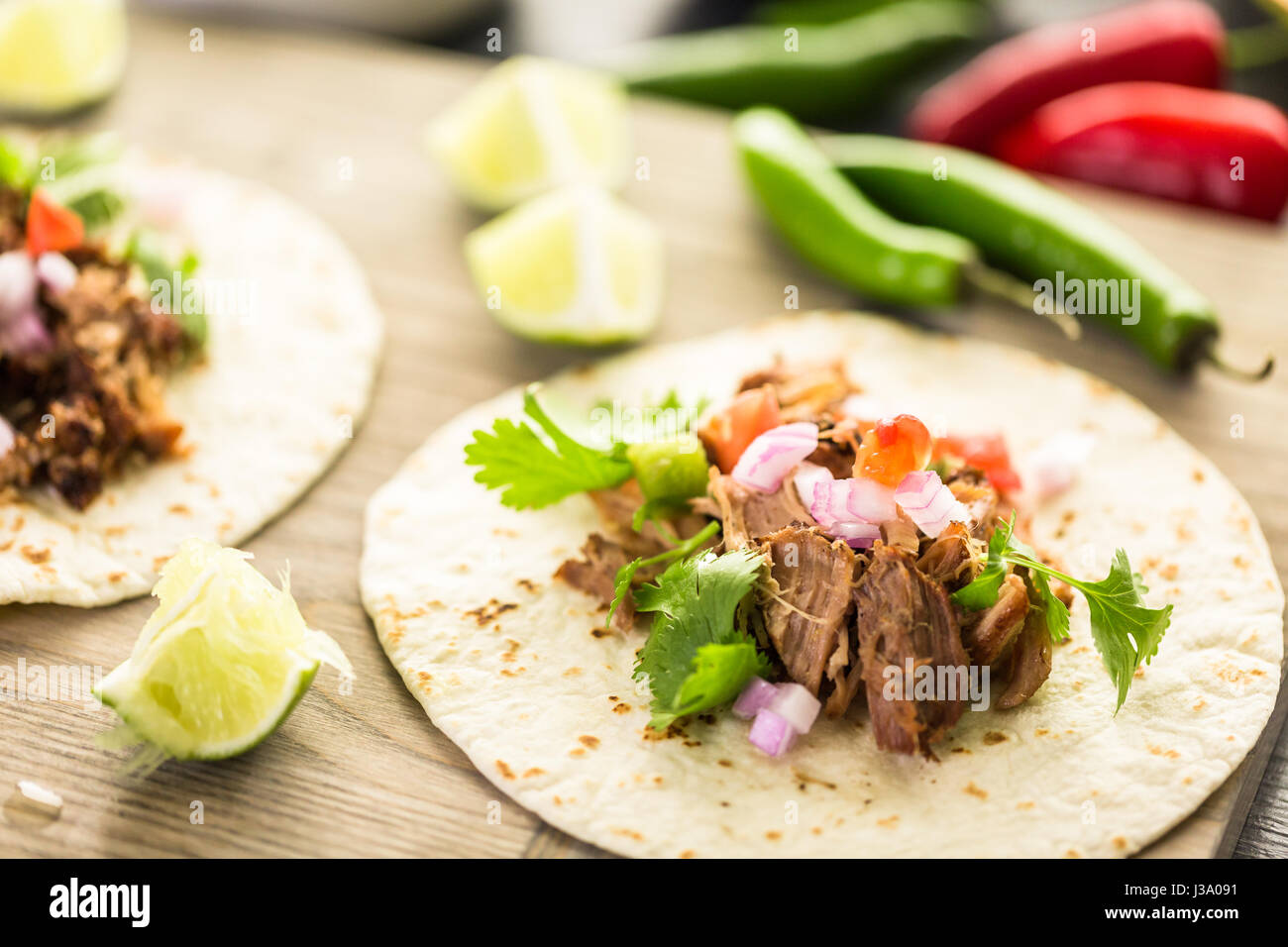 Pulled pork carnitas with pico de gallo on a flour tortilla Stock Photo ...