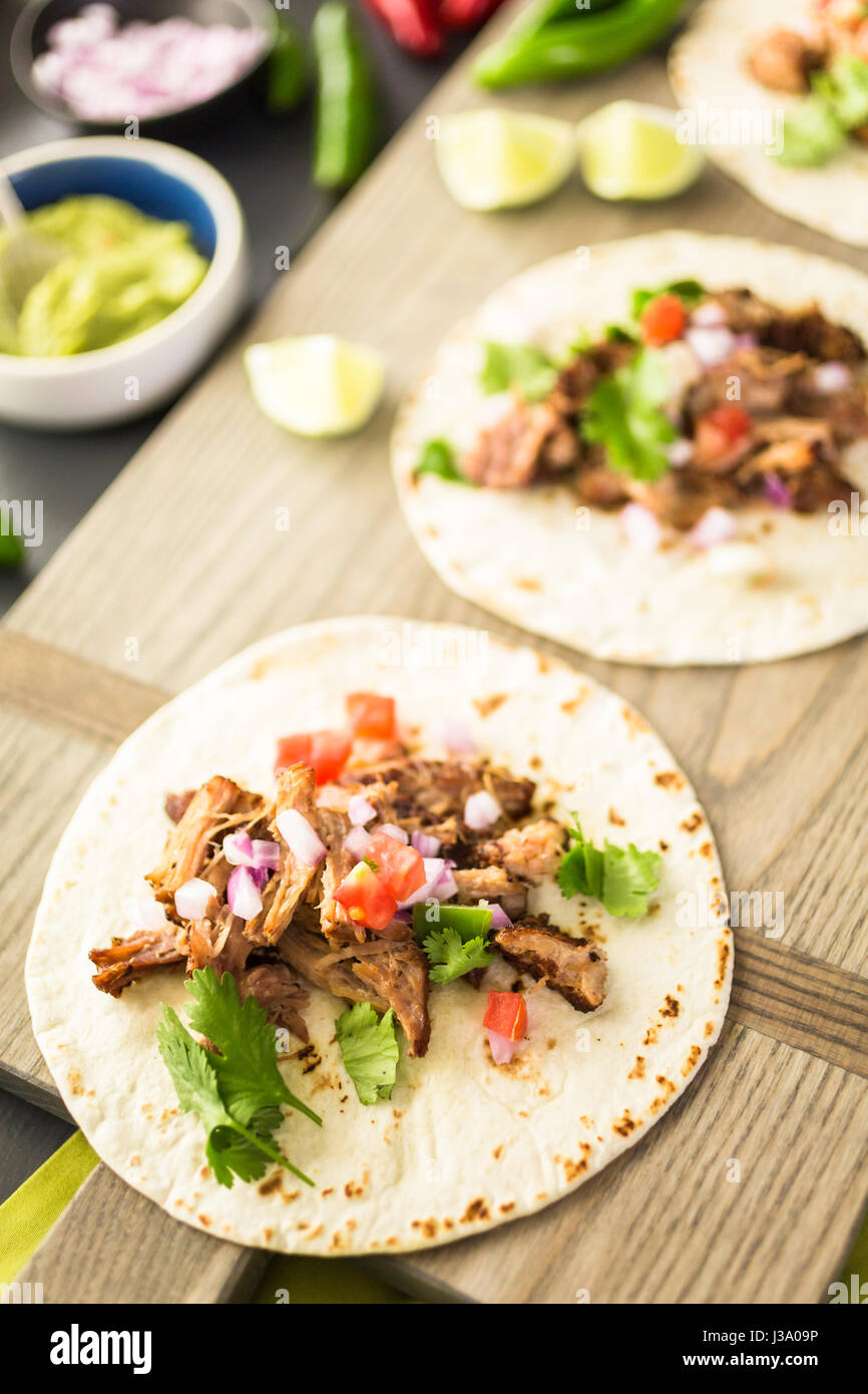 Pulled pork carnitas with pico de gallo on a flour tortilla Stock Photo ...