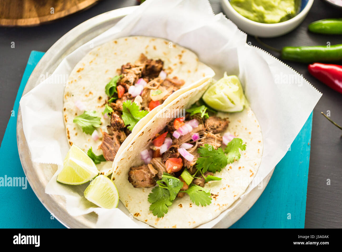 Pulled pork carnitas with pico de gallo on a flour tortilla Stock Photo ...