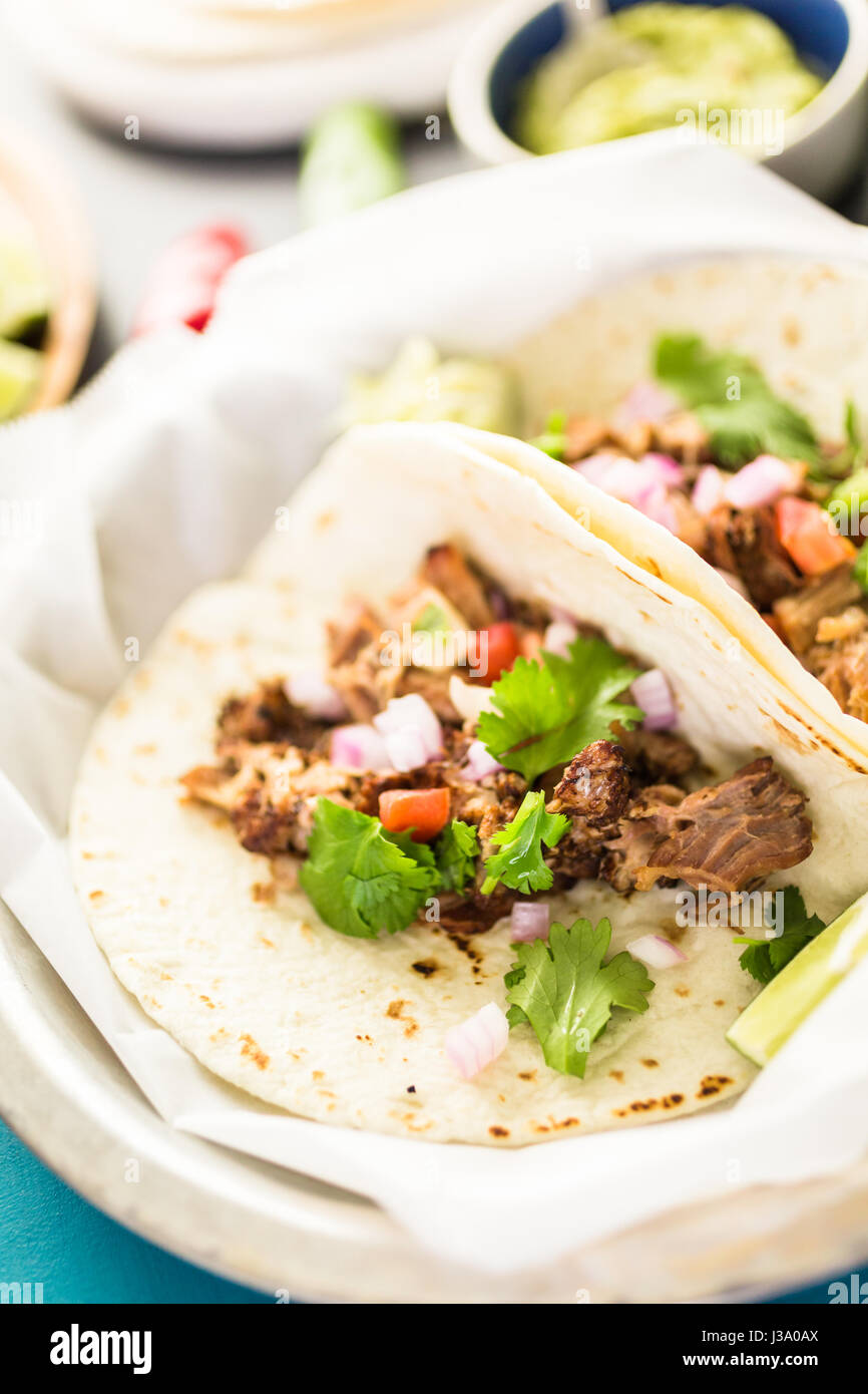 Pulled pork carnitas with pico de gallo on a flour tortilla Stock Photo ...