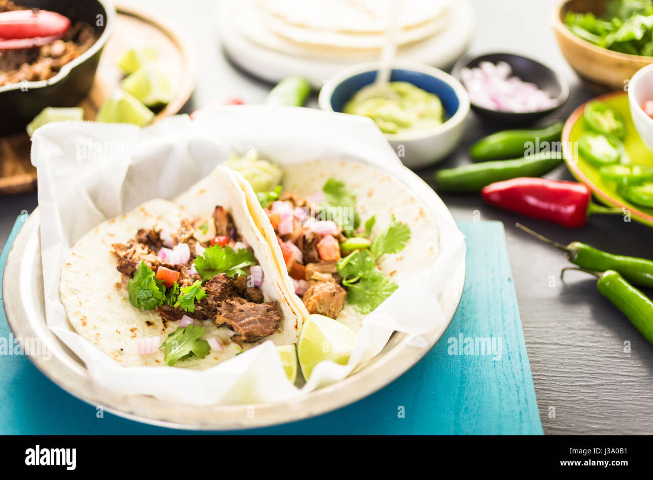 Pulled pork carnitas with pico de gallo on a flour tortilla Stock Photo ...