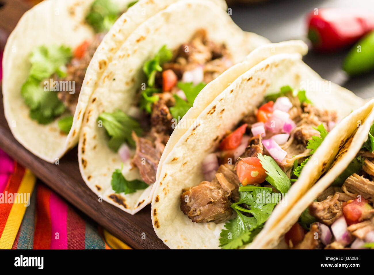Pulled pork carnitas with pico de gallo on a flour tortilla Stock Photo ...