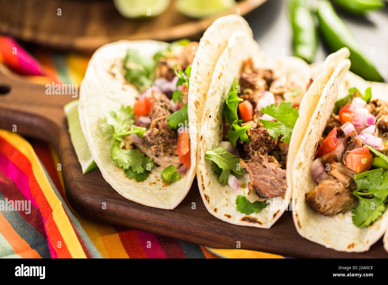 Pulled pork carnitas with pico de gallo on a flour tortilla Stock Photo ...