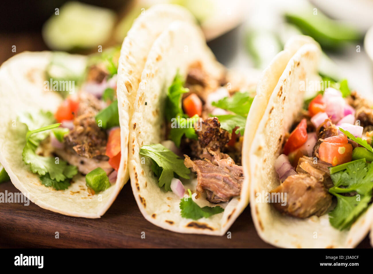 Pulled pork carnitas with pico de gallo on a flour tortilla Stock Photo ...