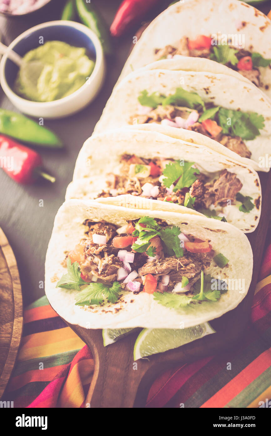 Pulled pork carnitas with pico de gallo on a flour tortilla Stock Photo ...