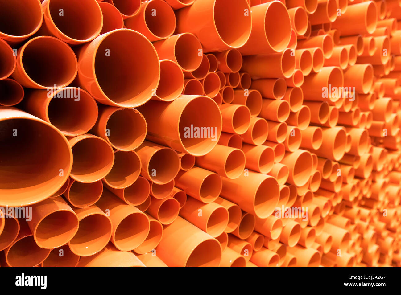 PVC pipes stacked in construction site Stock Photo - Alamy
