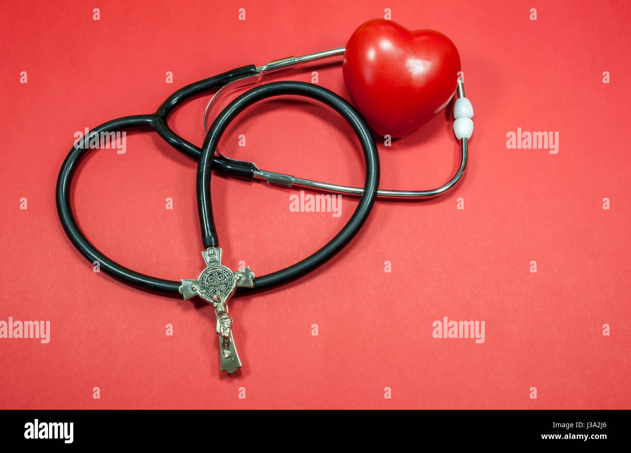 Medical stethoscope having at one end a Christian cross or crucifix ...