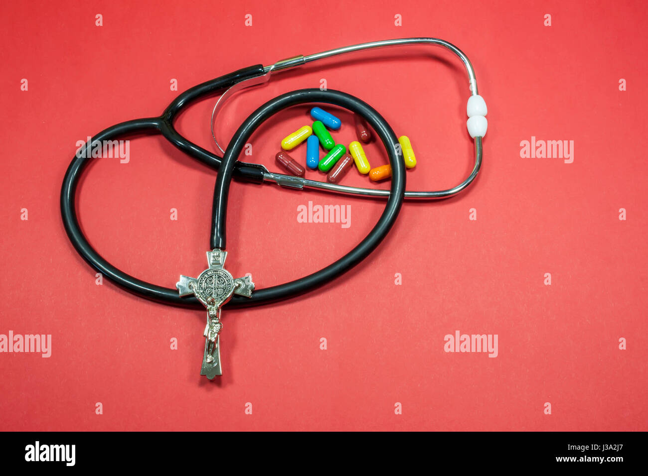 Medical stethoscope having at one end a Christian cross or crucifix ...