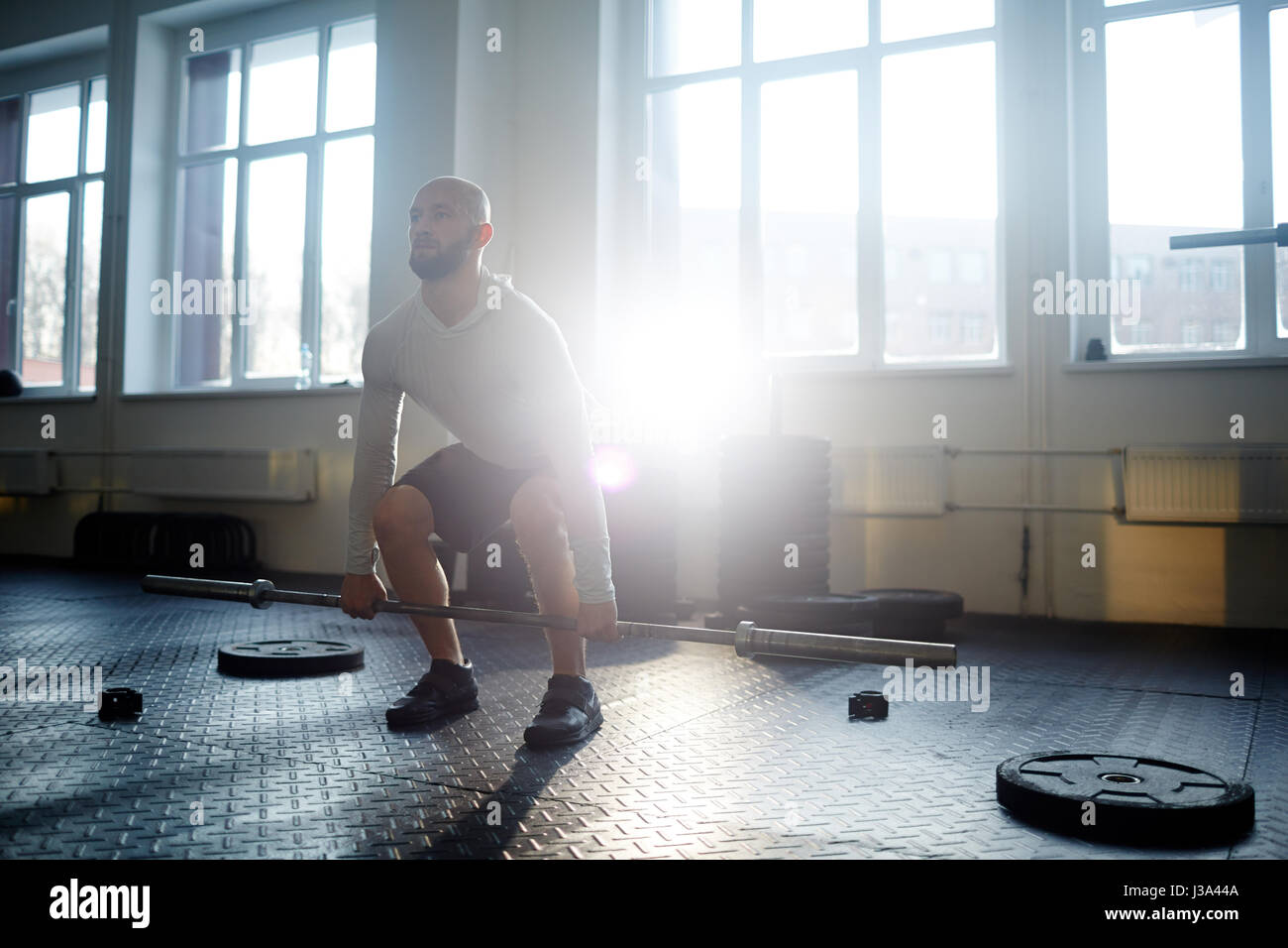Strong Man Lifting Barbell in Gym Stock Photo - Alamy