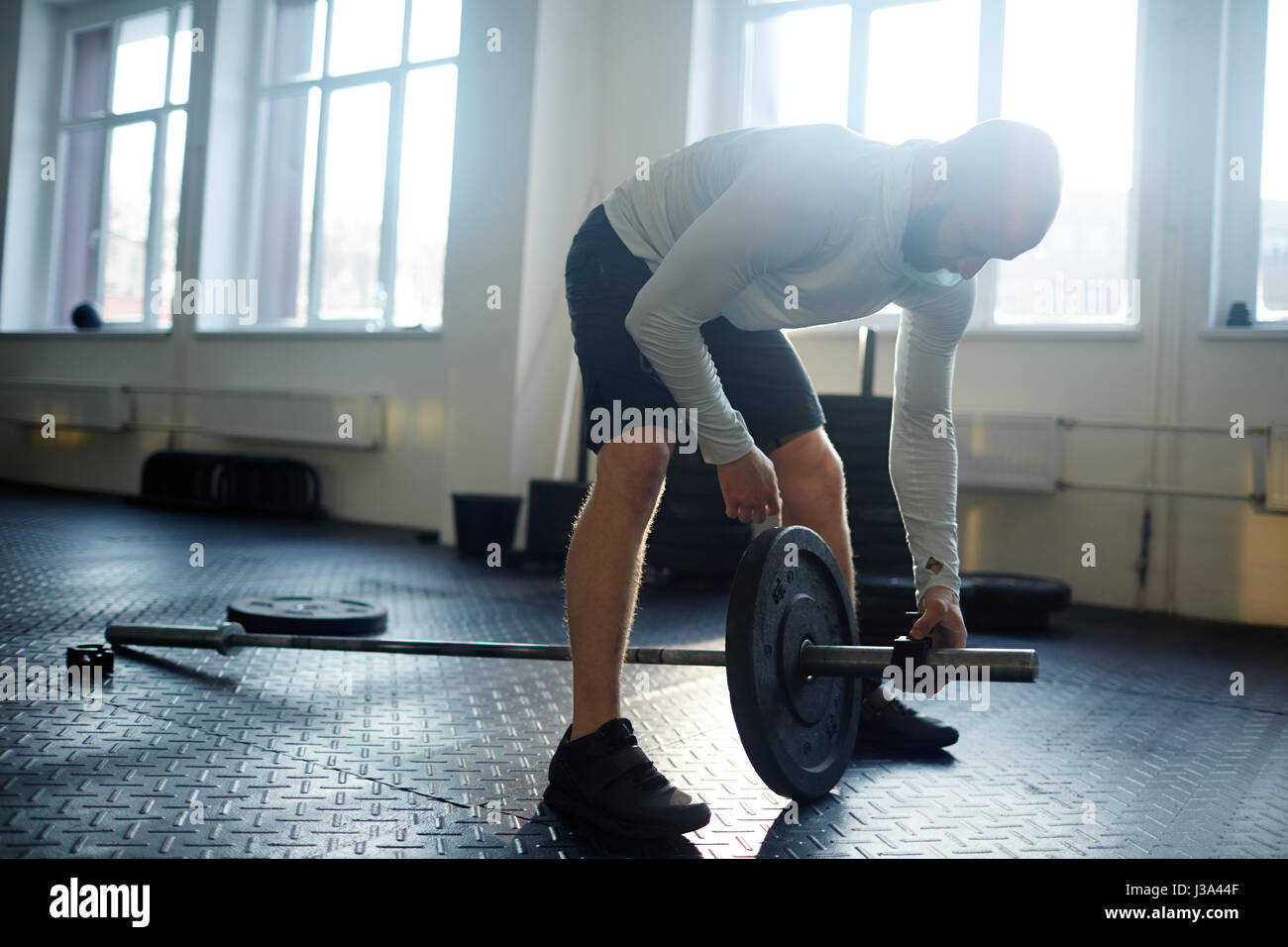 Strong Man Assembling Heavy Barbell Stock Photo - Alamy
