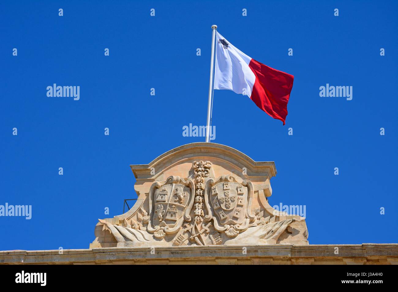 The coat of arms of Castille and Leon and Maltese flag on top of the ...