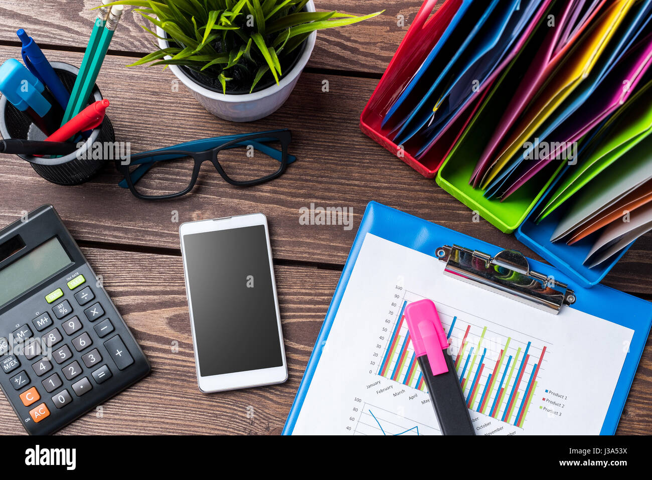 Office desktop with graphs and charts, documents and modern digital ...