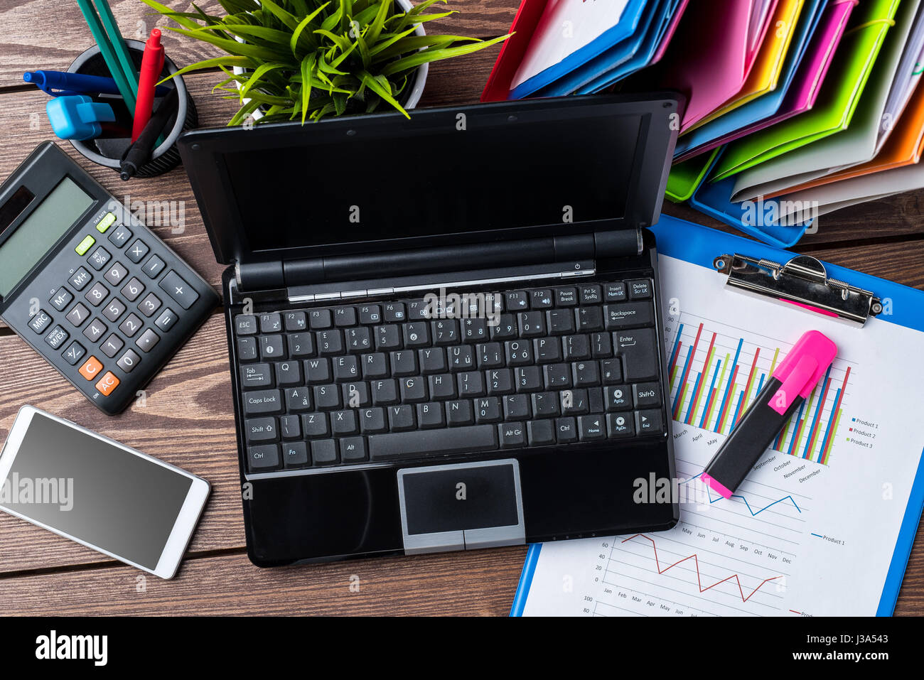 Office desktop with graphs and charts, documents and modern digital ...